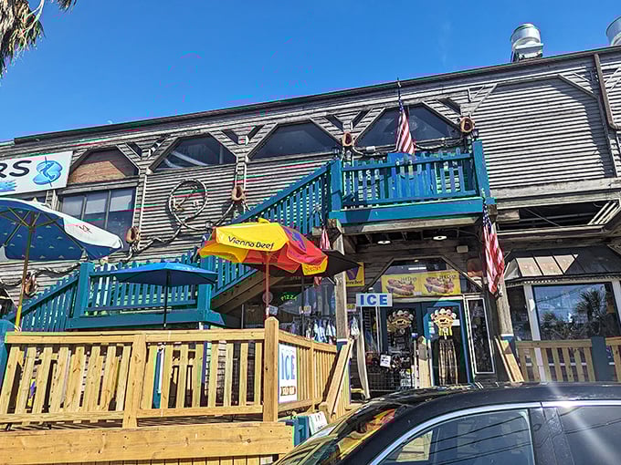 The weathered wooden exterior with bright blue railings isn't trying too hard—it's Florida authenticity that can't be manufactured or franchised.