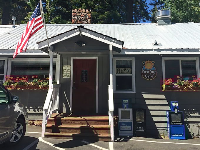 The unassuming exterior of Fire Sign Café stands like a breakfast speakeasy among Tahoe pines, its red door a portal to pancake paradise.