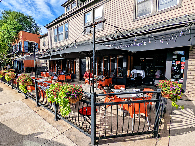Fahrenheit's charming patio beckons with vibrant orange tables and lush greenery, creating a sidewalk oasis in Cleveland's Tremont neighborhood.