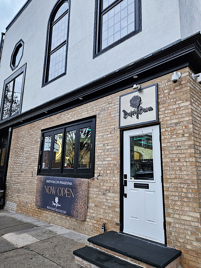 The unassuming brick exterior hides Philadelphia's pork paradise like a culinary speakeasy. Those planters aren't just pretty—they're guarding the gateway to flavor town.