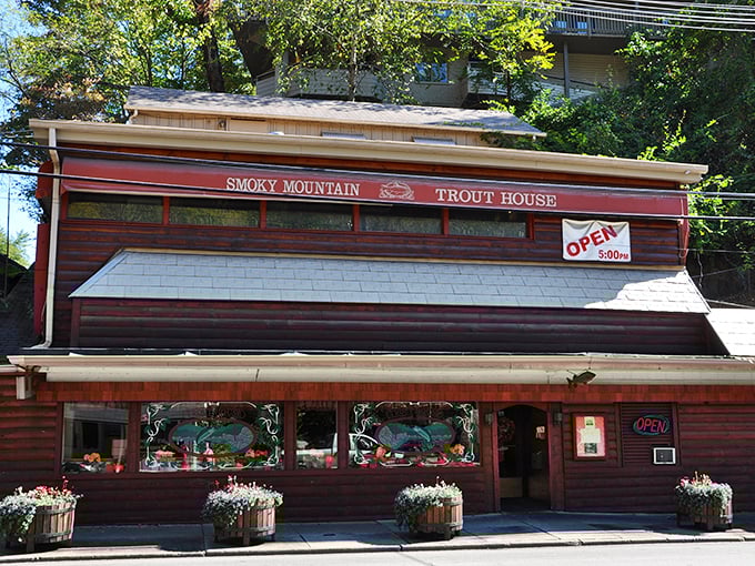 The rustic wooden exterior of Smoky Mountain Trout House stands like a culinary time capsule amid Gatlinburg's tourist attractions, promising authentic mountain flavors inside.