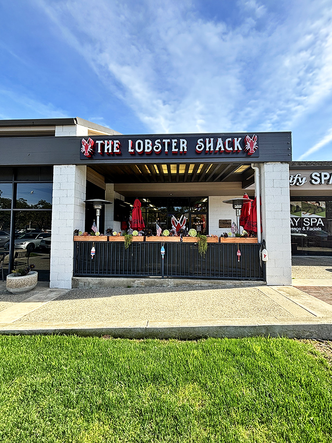 The bright red lobster signs flanking The Lobster Shack's entrance aren't just decoration—they're beacons calling seafood lovers to this unassuming strip mall treasure in Laguna Niguel.