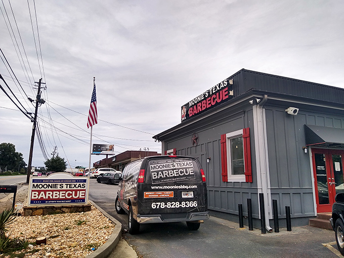 The unassuming exterior of Moonie's Texas BBQ stands like a smoke-scented beacon of hope for hungry travelers. That American flag isn't just decoration—it's a promise of patriotic flavor.