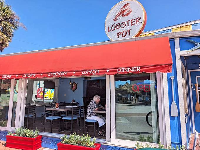 The iconic red awning and circular lobster sign beckon seafood lovers like a lighthouse guides ships home to New England shores.