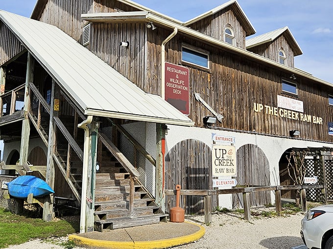 The weathered wooden exterior of Up the Creek Raw Bar stands as a testament to authentic Florida coastal charm, promising seafood treasures within.