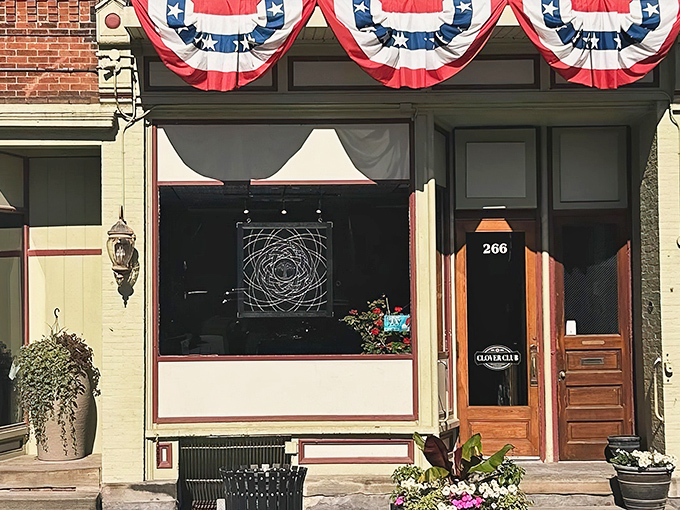 The patriotic bunting above Clover Club's storefront isn't just decoration—it's a promise that inside awaits the kind of all-American comfort food that makes you salute your sandwich.