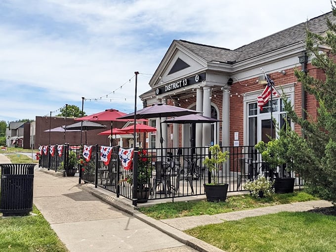 The architectural equivalent of a firm handshake – District 13's brick exterior with white columns promises small-town charm with big-city flavors waiting inside.
