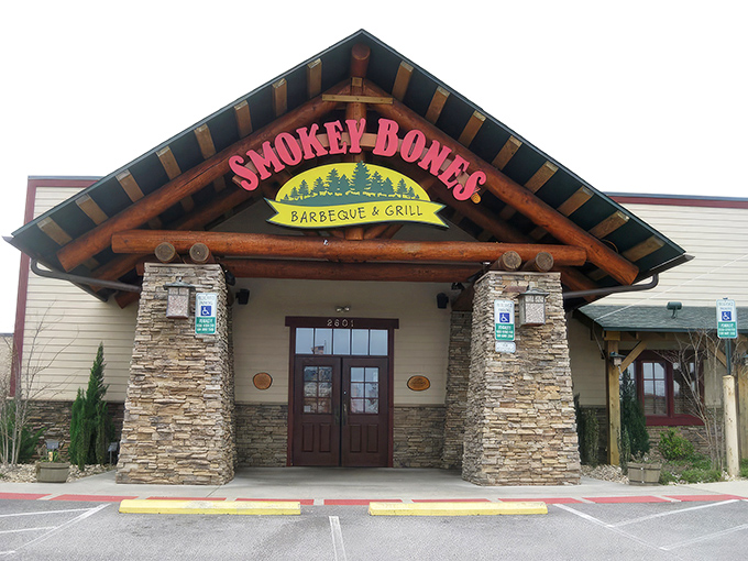 The rustic lodge-style exterior of Smokey Bones beckons like a carnivore's lighthouse in a sea of suburban shopping centers.