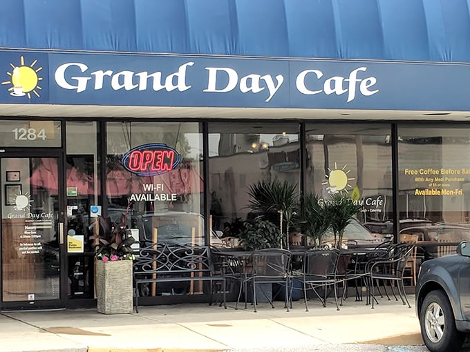 The blue awning of Grand Day Cafe beckons like a breakfast lighthouse, guiding hungry souls to a harbor of hash brown perfection.
