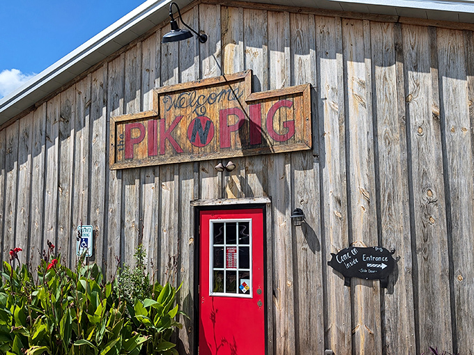 The weathered wooden exterior with that iconic red door isn't just inviting—it's practically whispering "get in here and eat something amazing."