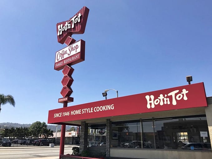 That iconic red arrow sign isn't just pointing to breakfast—it's directing you toward a time machine disguised as a diner. Pure roadside Americana at its finest.