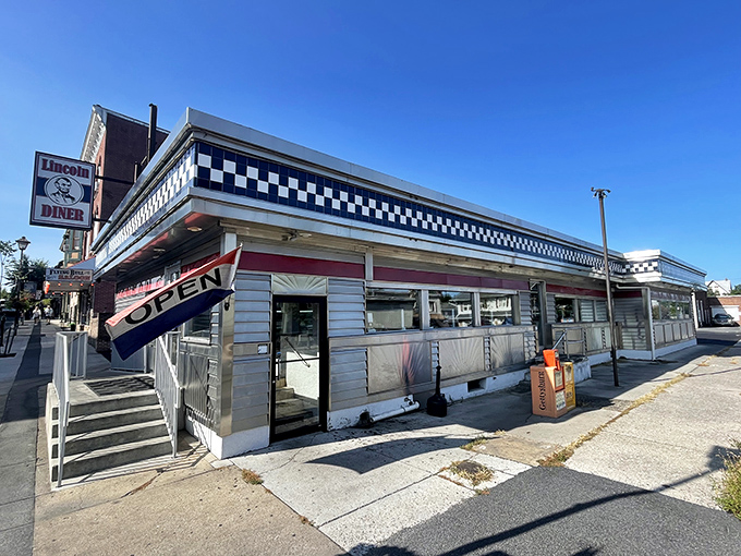 The classic stainless steel exterior of Lincoln Diner gleams in the sunlight, a time capsule of Americana where breakfast dreams come true.