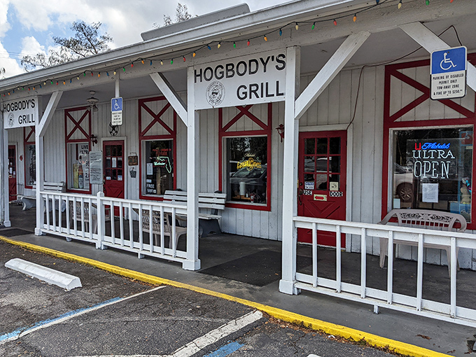 The barn-inspired exterior of Hogbody's, with its distinctive red doors and white clapboard, promises authentic flavors hiding behind that unassuming façade.