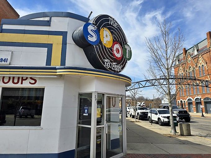 The blue and white Art Deco façade of The Spot stands proudly on Sidney's corner, its vintage neon sign beckoning hungry travelers like a culinary lighthouse.