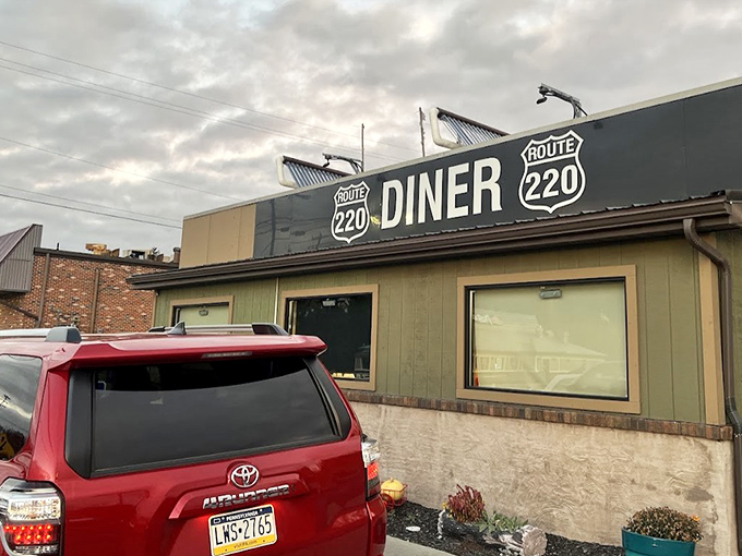 The unassuming exterior of Route 220 Diner stands like a culinary lighthouse for hungry travelers – no fancy frills, just the promise of honest food inside.
