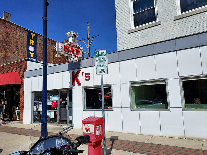The iconic K's storefront beckons with its vintage "EAT" sign – a neon command that's impossible to ignore and even harder to disobey.