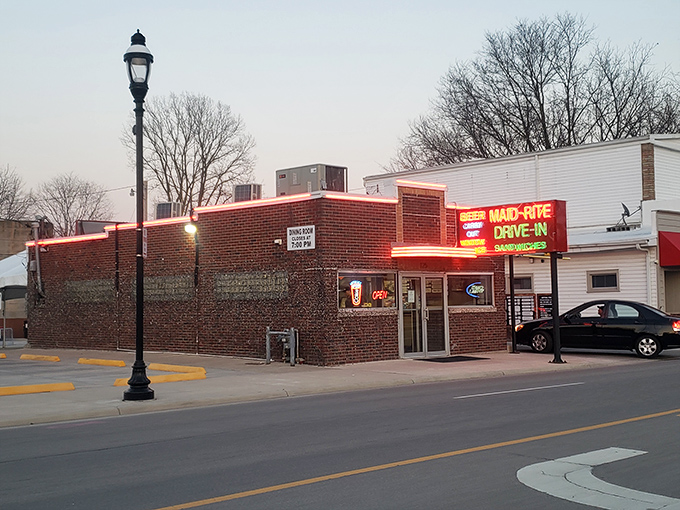 The neon beacon of Greenville! Maid-Rite's vintage sign promises three essential food groups: beer, sandwiches, and nostalgia—all available via drive-in window service.