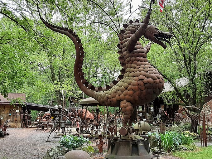The guardian dragon of Jurustic Park seems ready to take flight among the trees, its metallic scales gleaming like ancient armor in the Wisconsin sunlight.