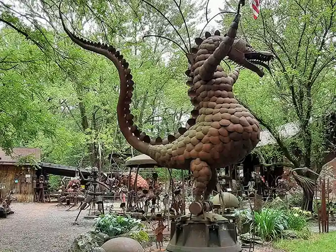 The guardian dragon of Jurustic Park seems ready to take flight among the trees, its metallic scales gleaming like ancient armor in the Wisconsin sunlight.