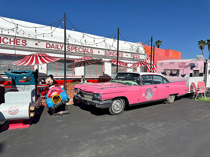 That pink Cadillac isn't just transportation—it's a time machine announcing your arrival to the 1950s. The ultimate greeting committee!