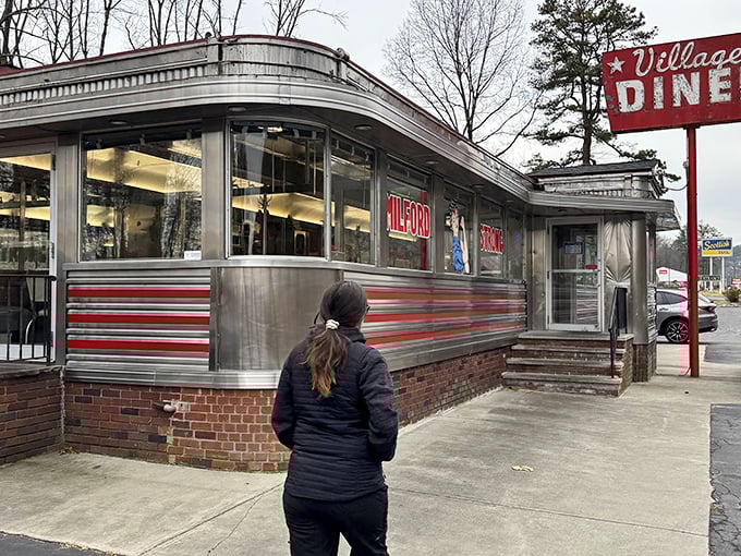 The classic stainless steel exterior with red trim announces you've arrived somewhere special—a genuine slice of Americana waiting in Milford.