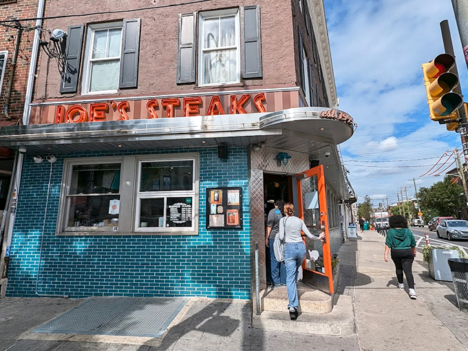 That iconic neon sign and turquoise tile exterior isn't just eye-catching—it's a time machine disguised as a corner shop in Philadelphia.