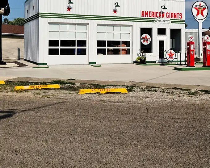 The gleaming white exterior of American Giants Museum beckons Route 66 travelers with vintage Texaco pumps standing guard like red sentinels of a bygone era.