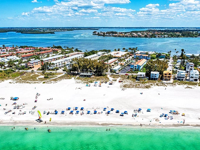 Where turquoise waters meet powdery white sand, Anna Maria Island stretches like nature's perfect welcome mat. This aerial view shows why locals guard their secret paradise fiercely.