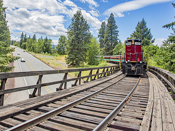 The iconic crimson and turquoise Mount Hood Railroad cuts through Oregon's wilderness like a living postcard, bringing nostalgic train travel and breathtaking scenery together in perfect harmony.