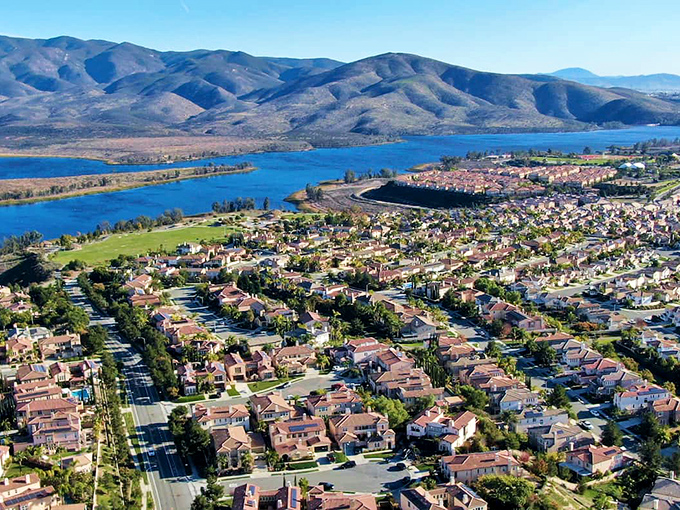 Suburban paradise meets natural splendor in Chula Vista, where red-tiled roofs complement the stunning backdrop of mountains and reservoir waters.