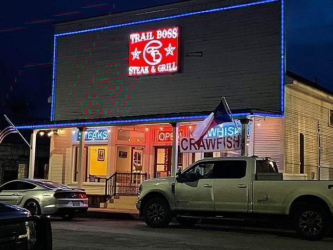 The neon-outlined Trail Boss sign glows like a beacon for hungry travelers. This unassuming exterior houses culinary treasures that would make any cowboy weep with joy.