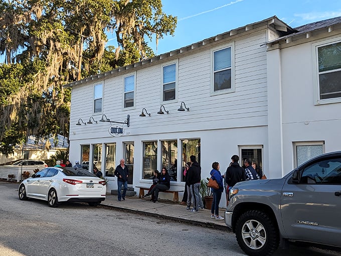 The line outside isn't a Florida mirage—it's breakfast devotees waiting for their morning salvation at this unassuming white building in historic Lincolnville.