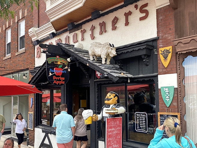 The iconic goat statue stands guard atop Baumgartner's entrance, welcoming cheese pilgrims to this Monroe landmark with quirky Wisconsin charm.