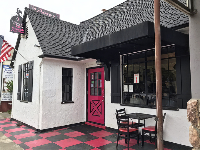 The pink door at Sax's Joint isn't just an entrance—it's a portal to comfort food nirvana. The checkerboard patio practically screams "good times ahead!"