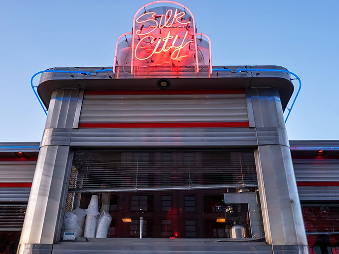 That neon glow against the twilight sky isn't just a sign—it's a beacon calling hungry souls to food nirvana.
