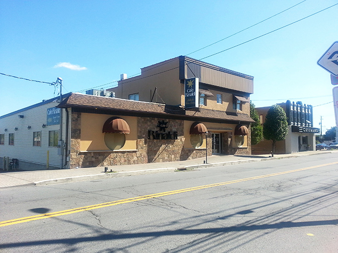 The unassuming exterior of Cafe Rinaldi stands like a culinary sentinel on Old Forge's main drag, copper awnings beckoning hungry travelers to step inside.