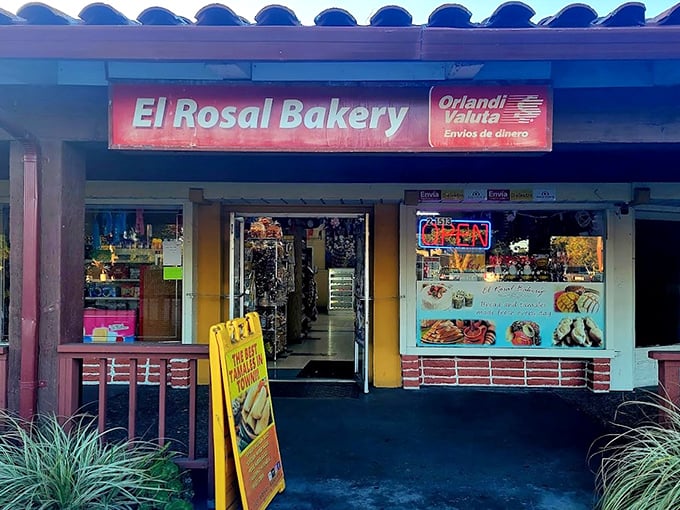 The unassuming storefront of El Rosal Bakery beckons with its blue-tiled roof and bright red sign—proof that culinary treasures often hide in plain sight.