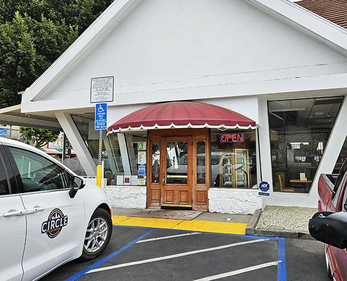 The iconic A-frame exterior stands like a beacon of comfort food, promising sweet salvation under the California sun.