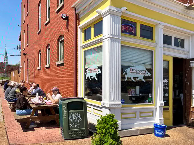 The bright yellow corner building beckons like a barbecue lighthouse in Soulard. Those picnic tables aren't just seating—they're front-row tickets to flavor town.