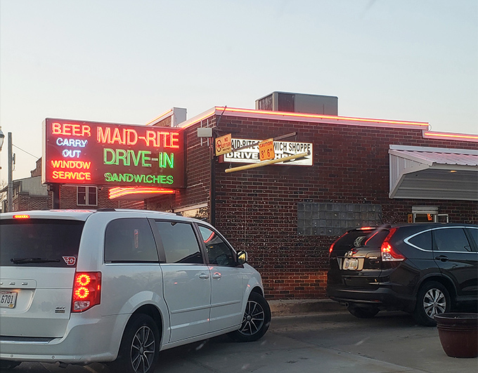 The neon glow of culinary history! Maid-Rite's vintage signage promises drive-in service and sandwiches that have stood the test of time.