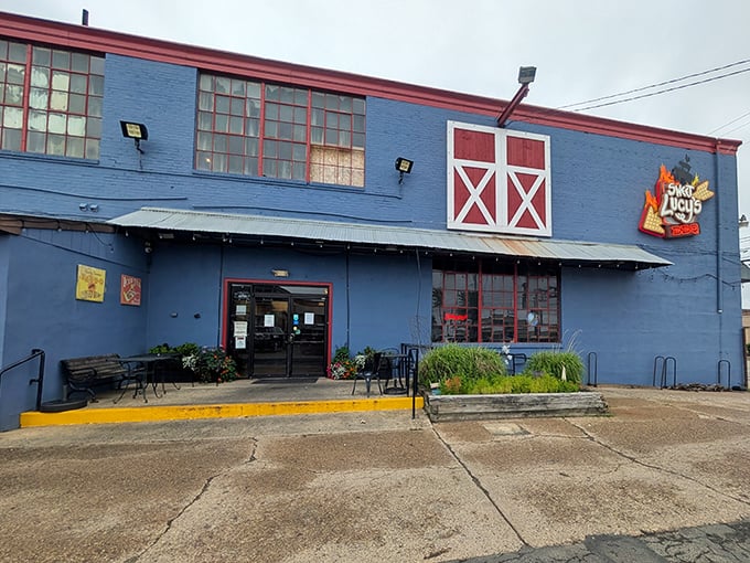 The blue barn-like exterior with its distinctive red trim isn't just eye-catching—it's a smoke signal to BBQ lovers that authentic goodness awaits inside.
