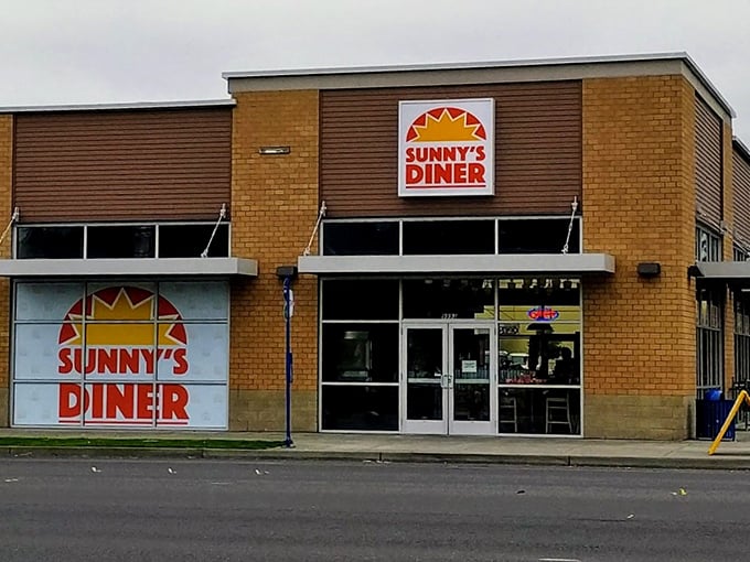 The bright sun logo beckons like a breakfast lighthouse, promising morning salvation in brick-and-mortar form at Happy Valley's beloved Sunny's Diner.