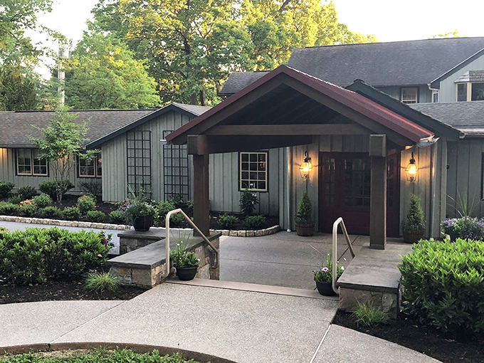 The welcoming entrance to The Log Cabin beckons like an old friend, promising warmth and culinary delights amid Pennsylvania's lush countryside.