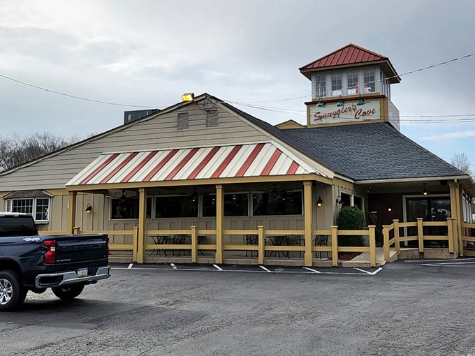 The iconic red-striped awning and lighthouse-inspired tower of Smuggler's Cove stands as a beacon for seafood lovers lost in the Pocono Mountains.