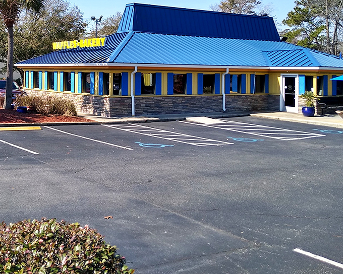 The sunshine-yellow exterior with that unmistakable blue roof isn't just a building—it's a morning beacon of breakfast possibilities waiting to happen.