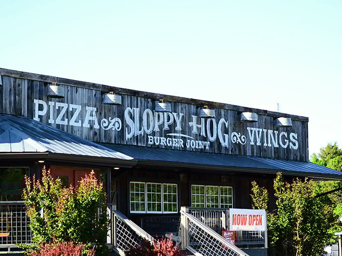 The rustic wooden facade of Sloppy Hog promises exactly what you want in a roadside find—authenticity without pretension and flavors worth the journey.