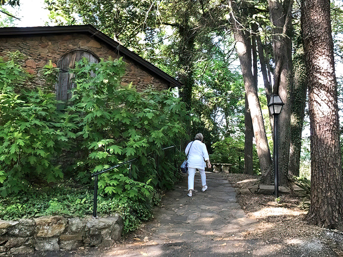 A stone cottage nestled among towering trees isn't just fairy tale scenery—it's your first clue that The Peddler isn't your average strip mall steakhouse.