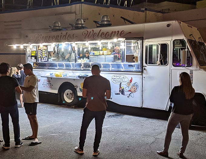 The glowing "Bienvenidos" sign on this unassuming white truck promises more culinary joy than most five-star restaurants could ever deliver.