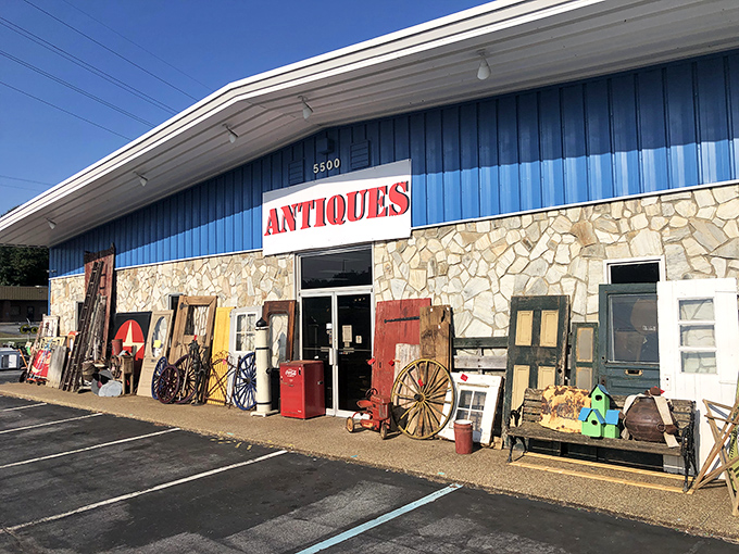 The blue facade with stone accents isn't just a building—it's a portal to treasures waiting to be discovered. Antiques spill onto the sidewalk, offering a tantalizing preview.