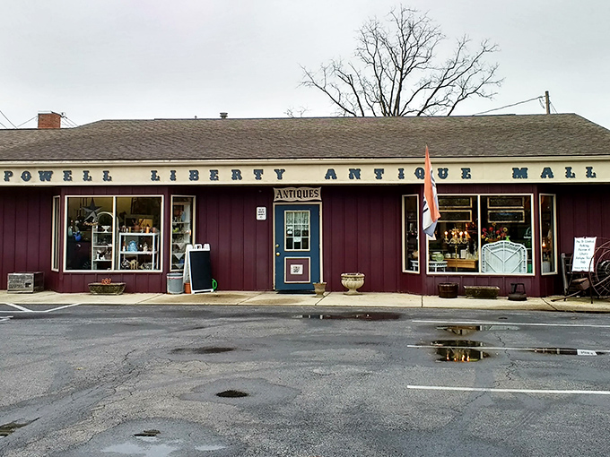 The unassuming burgundy exterior of Powell Liberty Antique Mall hides a universe of treasures inside, like a time-travel portal disguised as a country store.